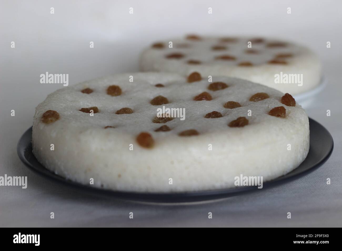 Spongy steamed rice cakes prepared with a fermented batter of rice and ...