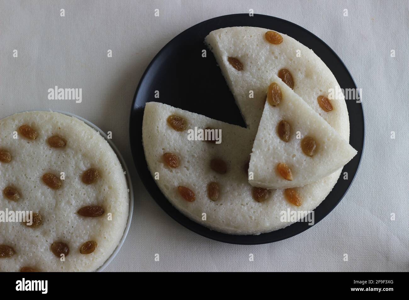 Spongy steamed rice cakes prepared with a fermented batter of rice and ...