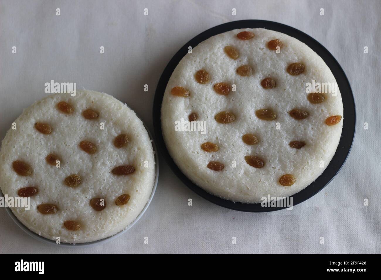 Spongy steamed rice cakes prepared with a fermented batter of rice and ...
