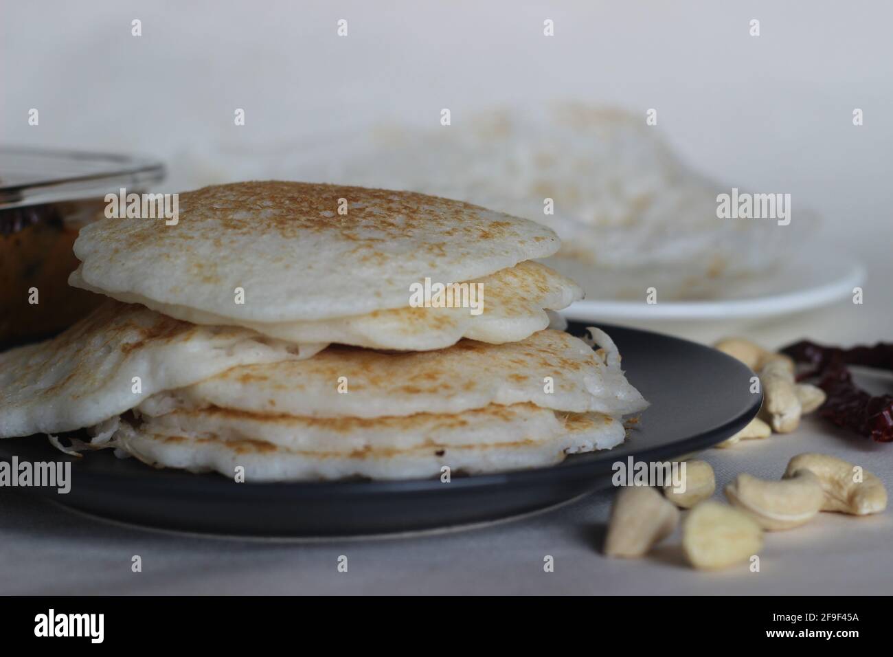 Rice pancakes and Hoppers. Two types of red rice breakfast dishes along ...