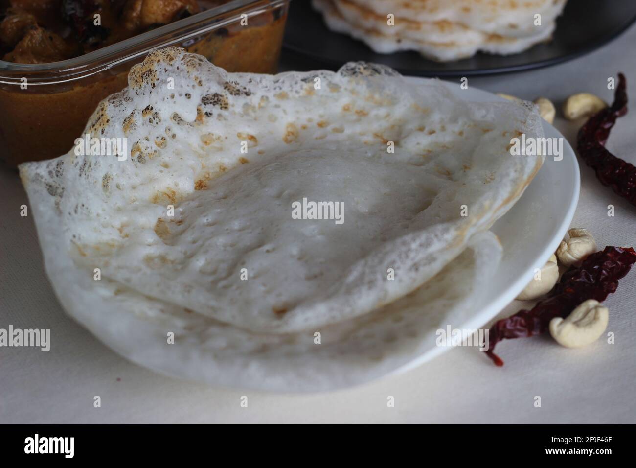 Hoppers and rice pancakes. Two types of red rice breakfast dishes along ...
