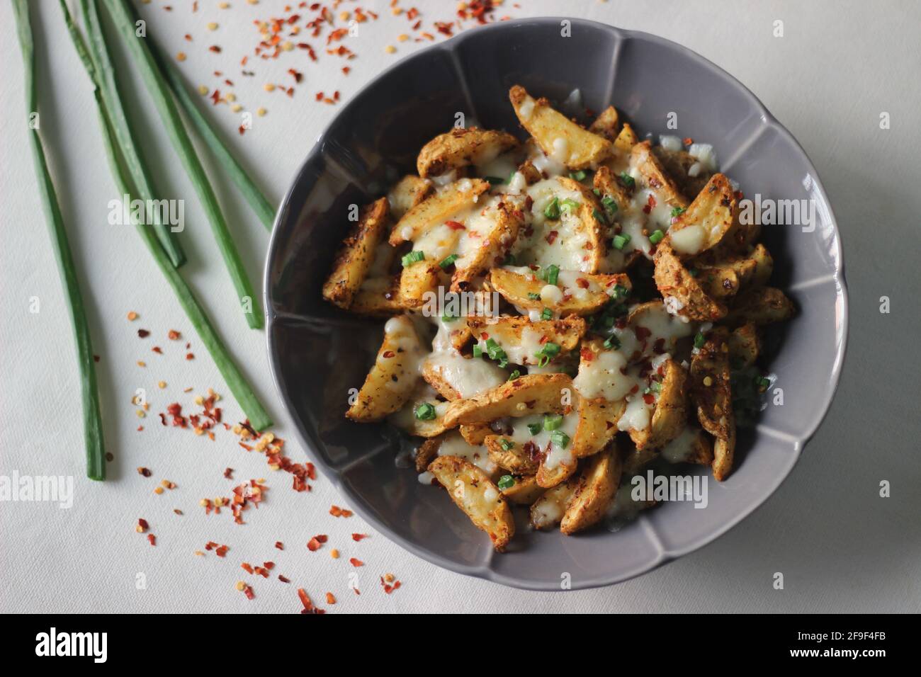 Cheesy potato wedges made by baking air fried potato wedges after ...