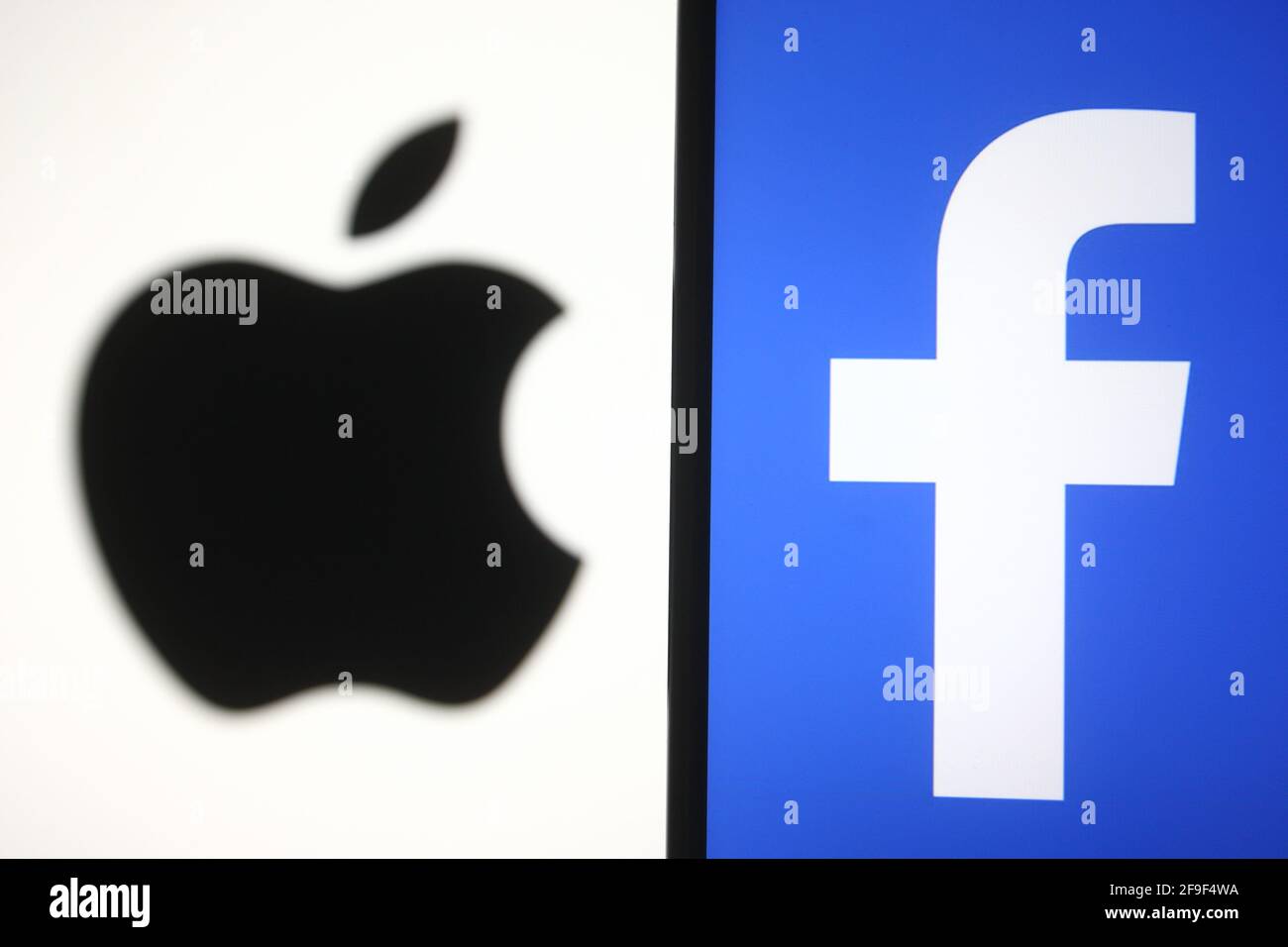 In this photo illustration, Apple and Facebook logos seen displayed on ...