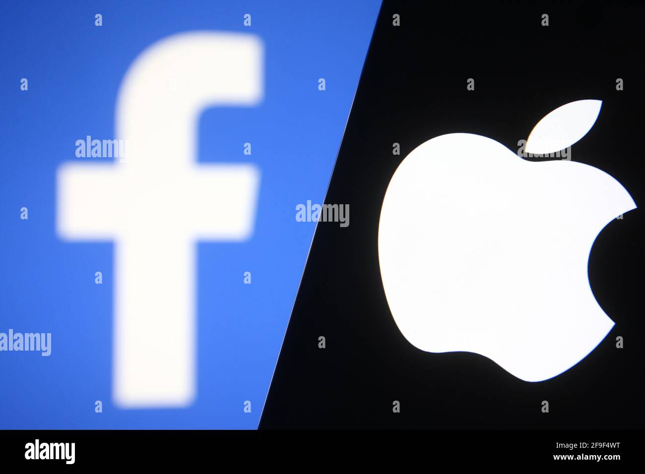In this photo illustration, an Apple and Facebook logos seen displayed ...