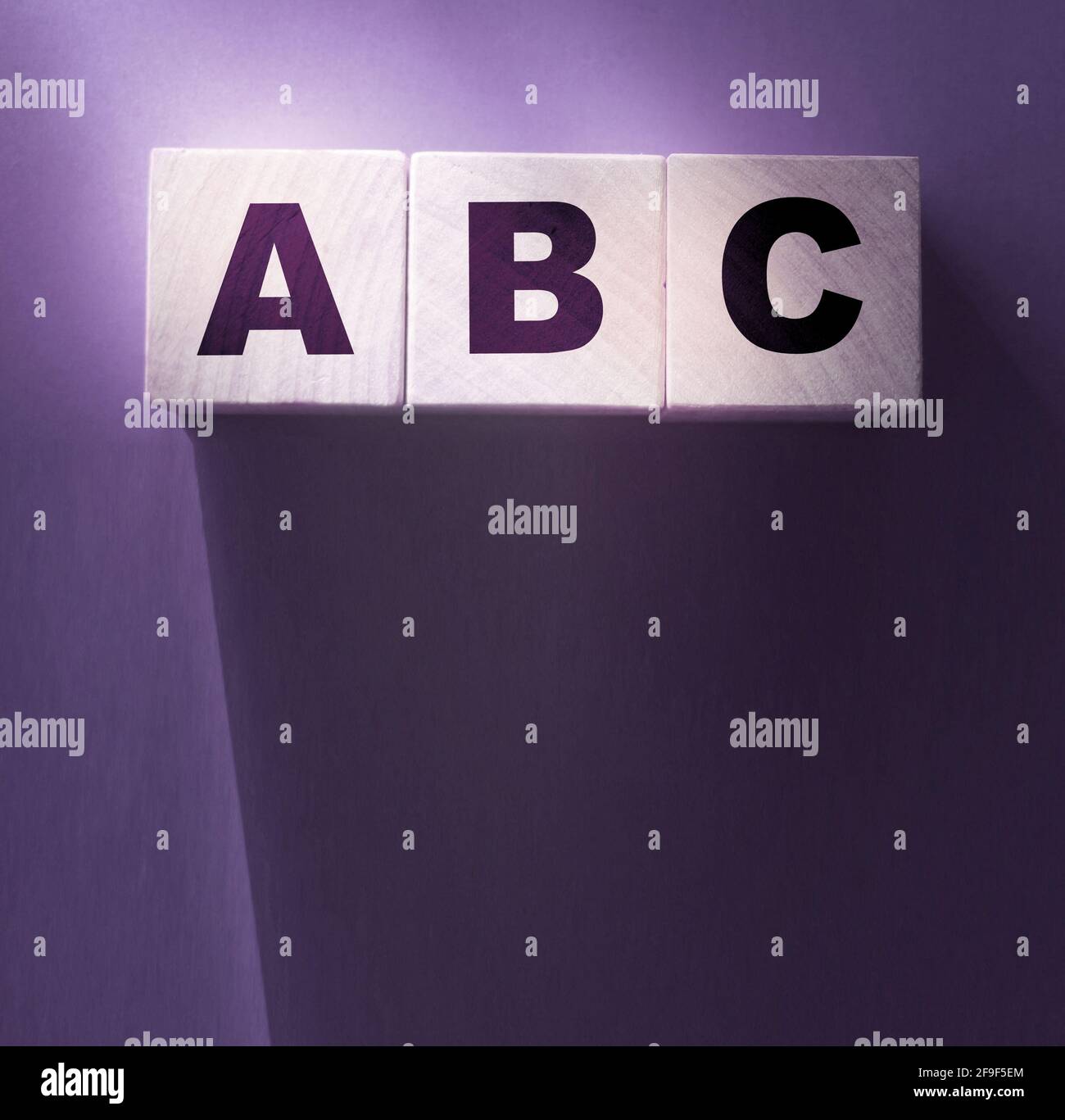 ABC letters wooden blocks on purple background. Education concept Stock ...