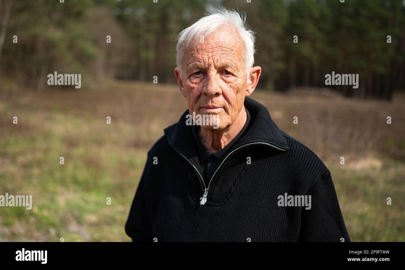 Lohheide, Germany. 18th Apr, 2021. Rolf Becker, actor, stands on a ...