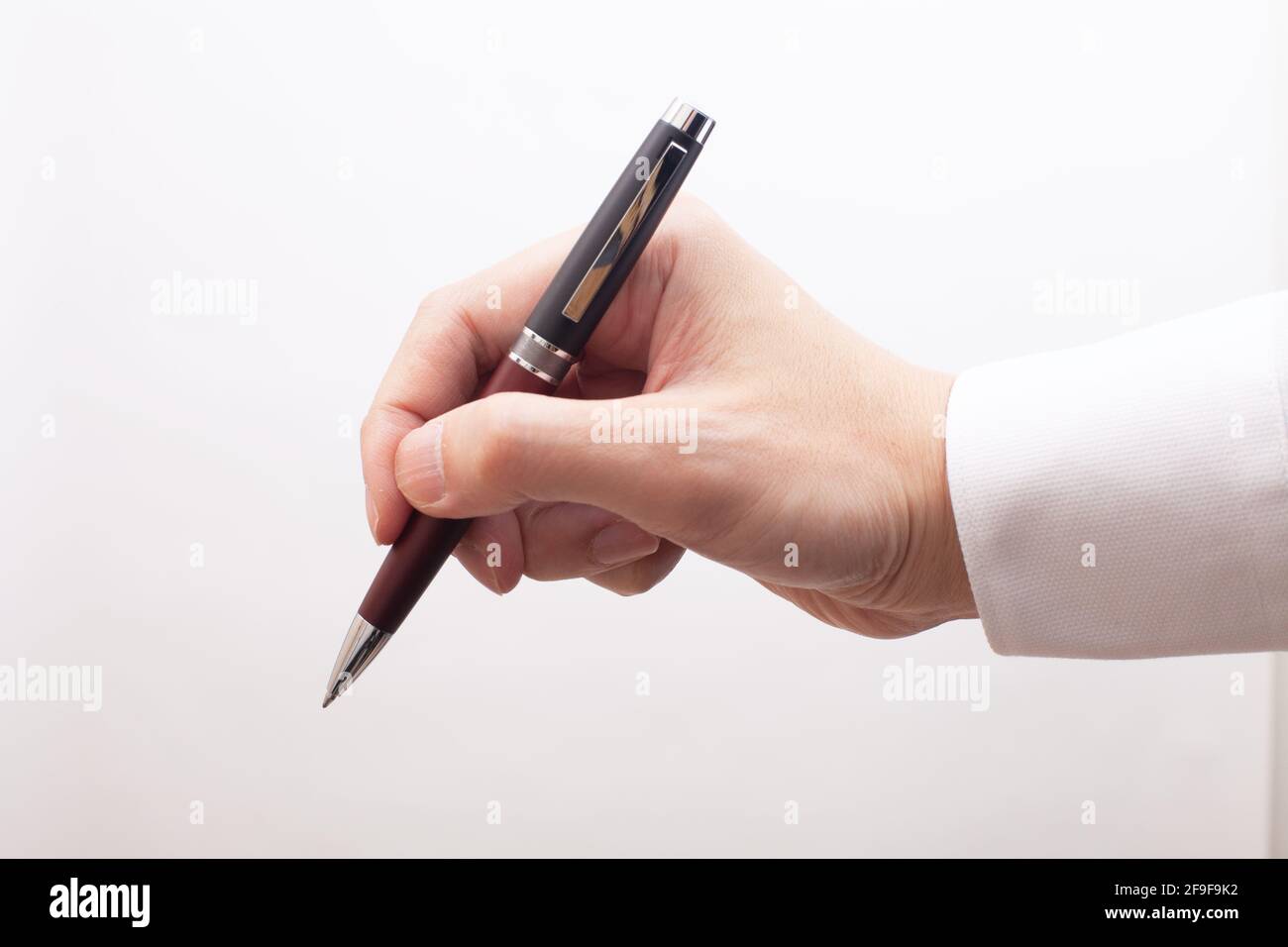 Male hand holding a ballpoint pen Stock Photo - Alamy