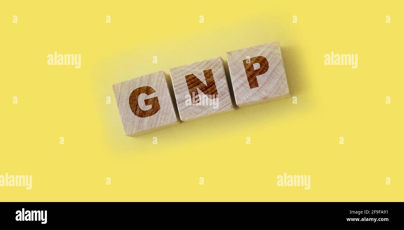 GNP Gross Domestic Product word made with wooden blocks on yellow ...