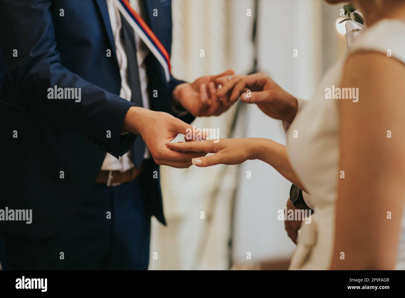 A shallow focus of a couple exchanging rings in their wedding ceremony ...
