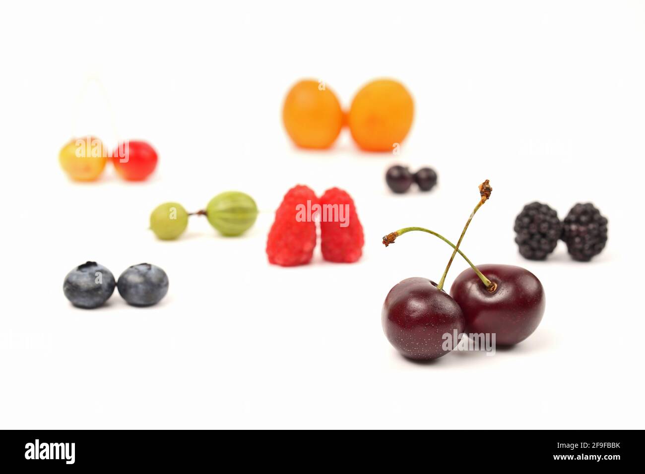 different berries are paired on a white background Stock Photo - Alamy