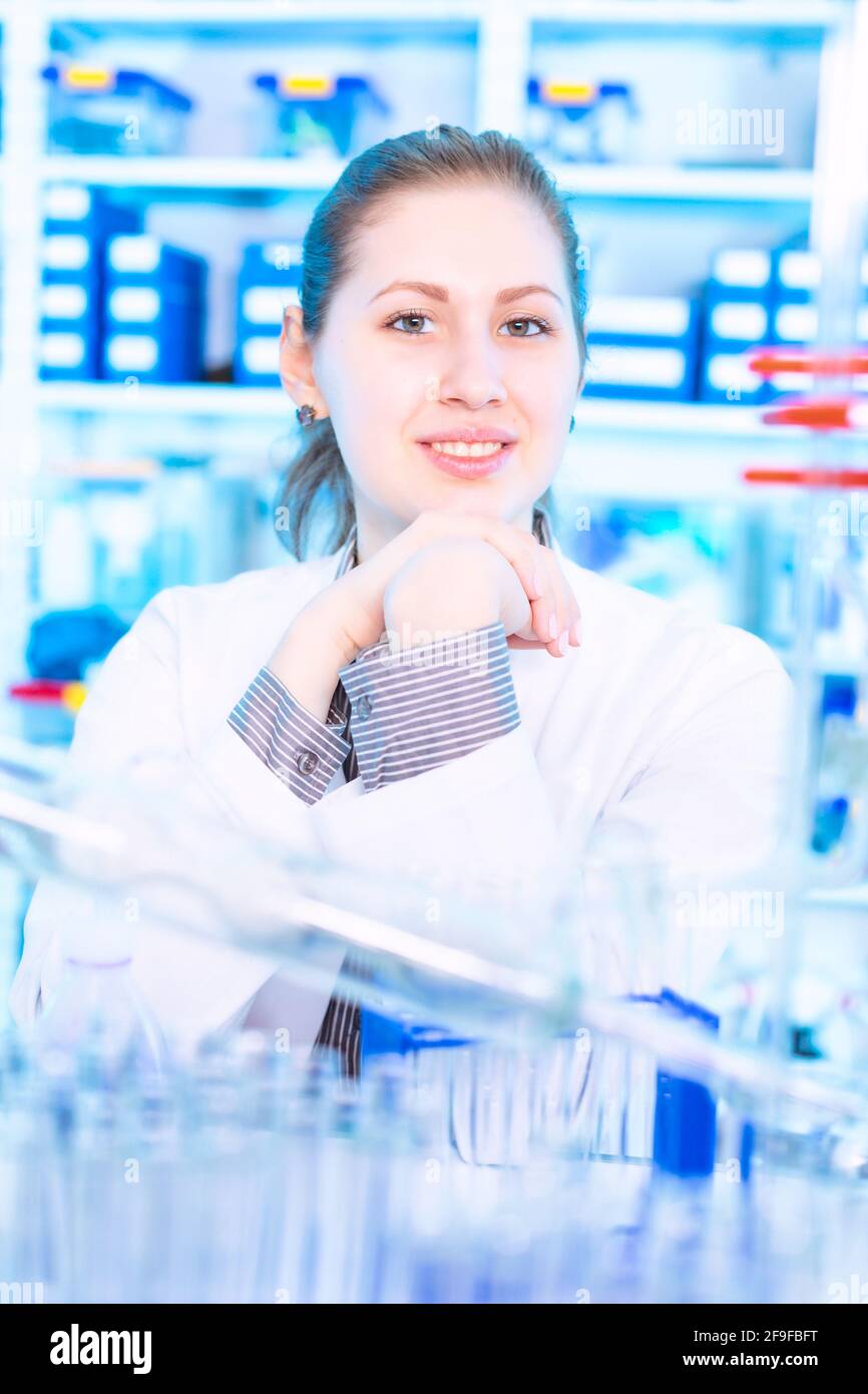 Young female student at university chemistry laboratory smiling and ...