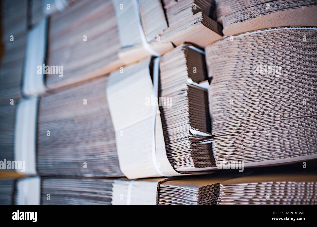 Close-up sides of stacks of cardboard folded Stock Photo - Alamy
