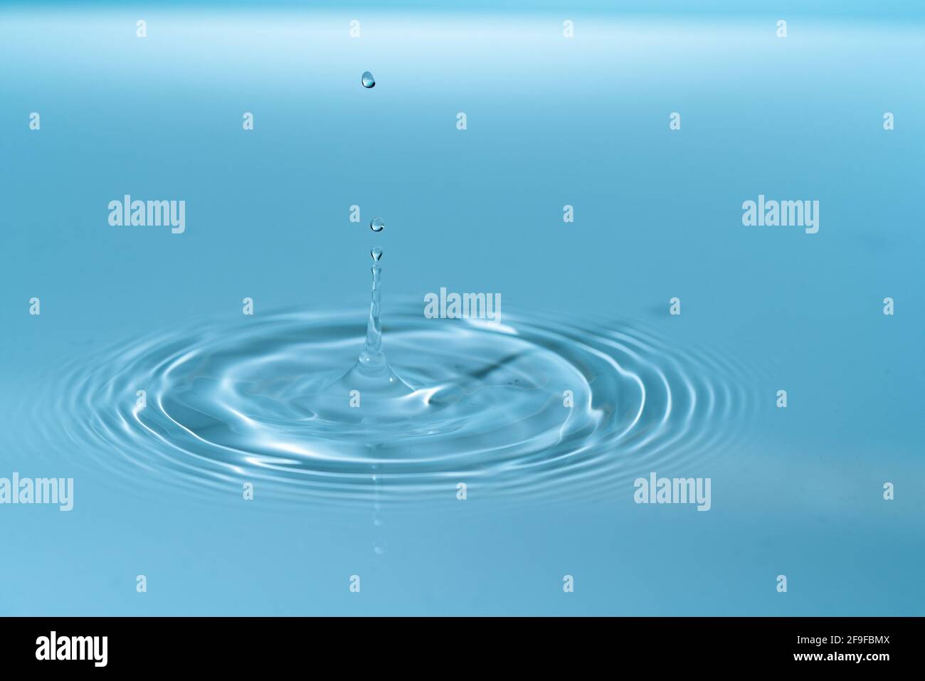 Waves on the surface of the water from a collision. Drop of water drop ...
