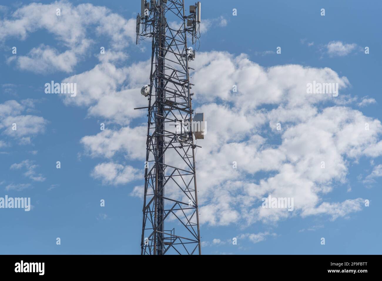 Cell phone data transmission tower on blue natural background ...