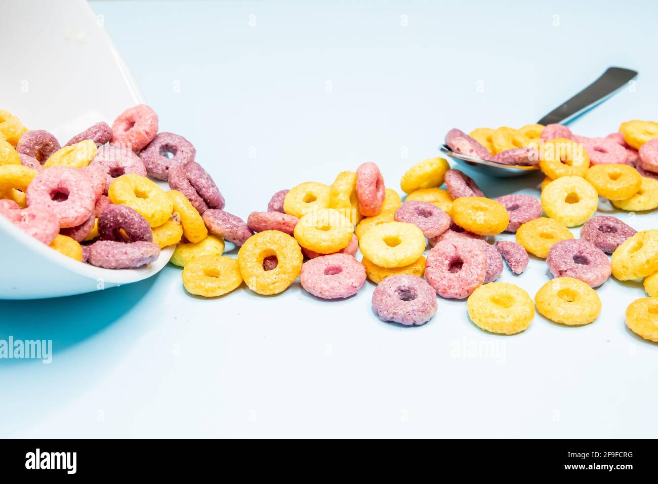 A closeup shot of colorful tasty and crunchy cereal being poured out of ...