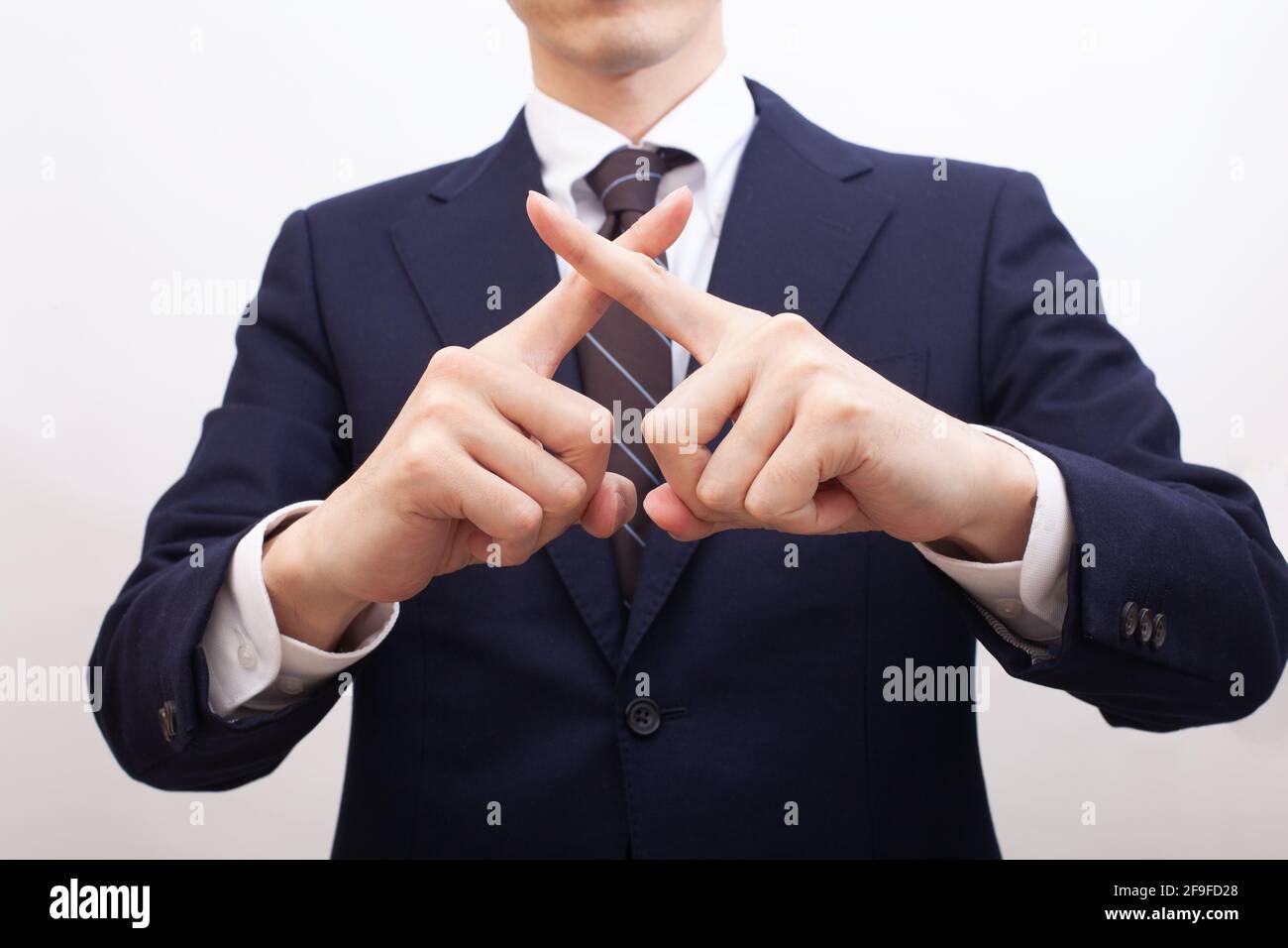 A hand sign prohibiting men in suits making cross marks with their ...