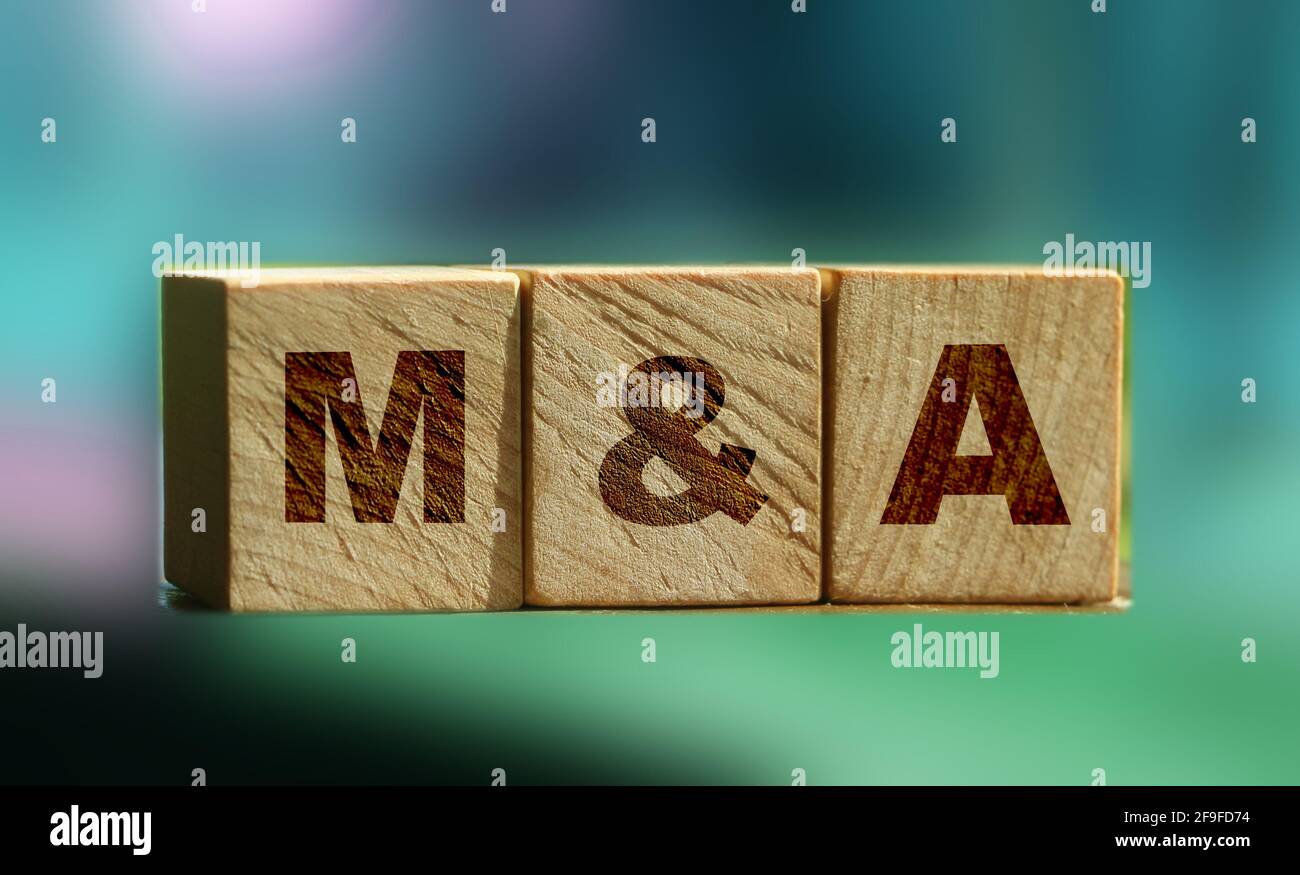 Wooden cubes with the abbreviation M and A on them. Business merges and ...