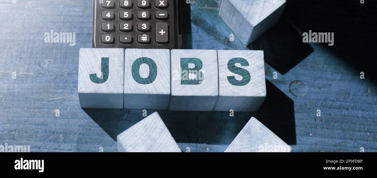 Jobs word made with wooden blocks on desk with calculator. Business ...