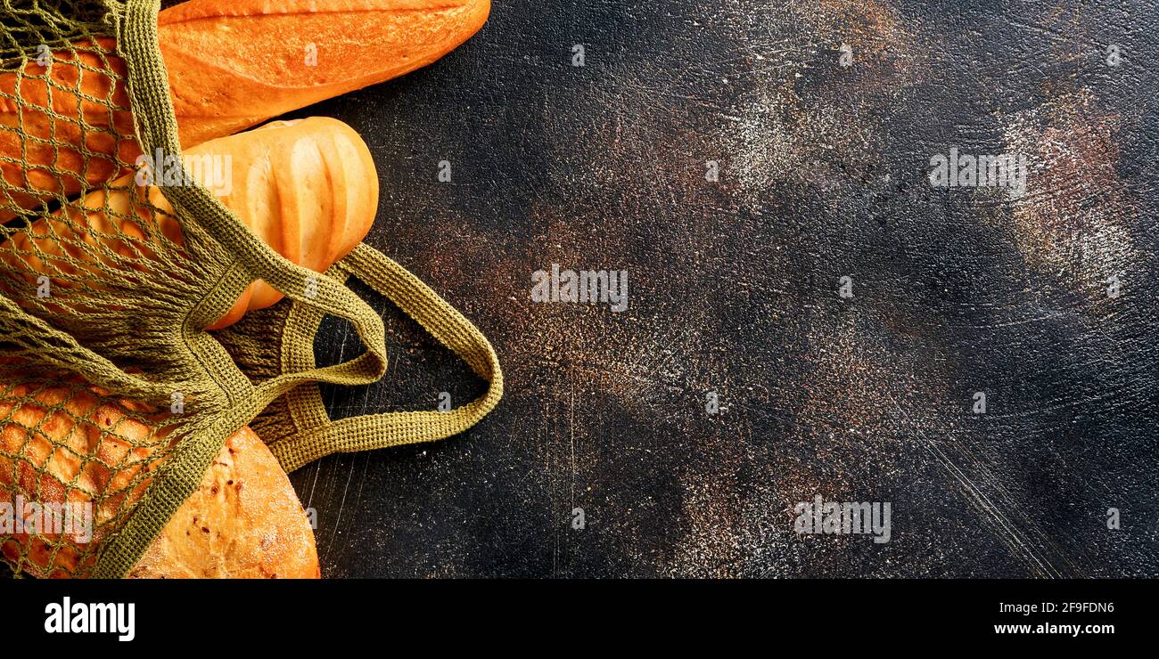 Various crispy breads and buns in mesh bags or shopping bag, wheat ...