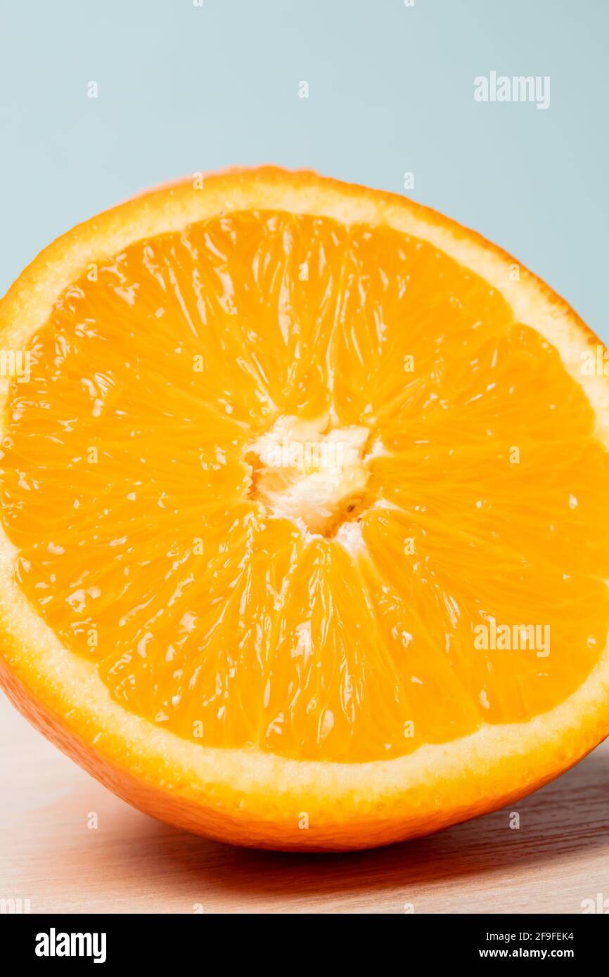 A vertical shot of a freshly sliced Spanish orange harvested from ...