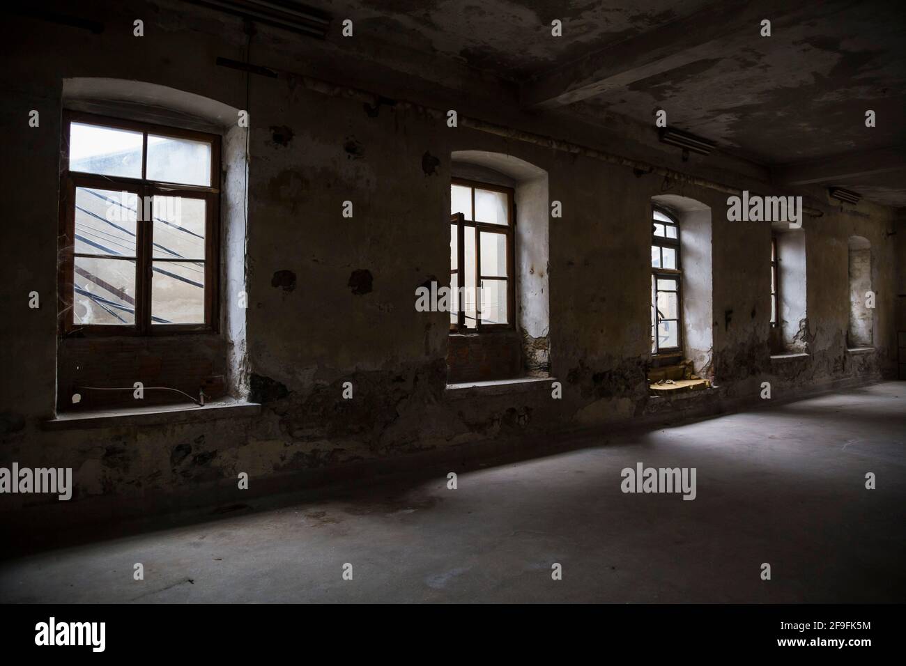 interior of an abandoned building with damaged walls and windows Stock ...