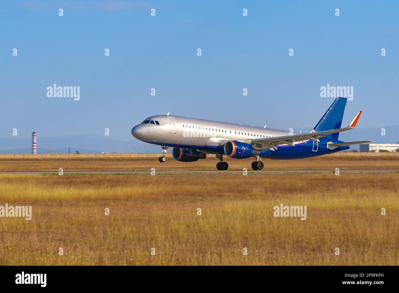 Passenger plane takes off from runway in airport Stock Photo - Alamy