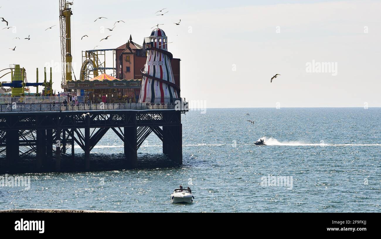 Brighton UK 18th April 2021 - Brighton seafront and beach is busy on a ...