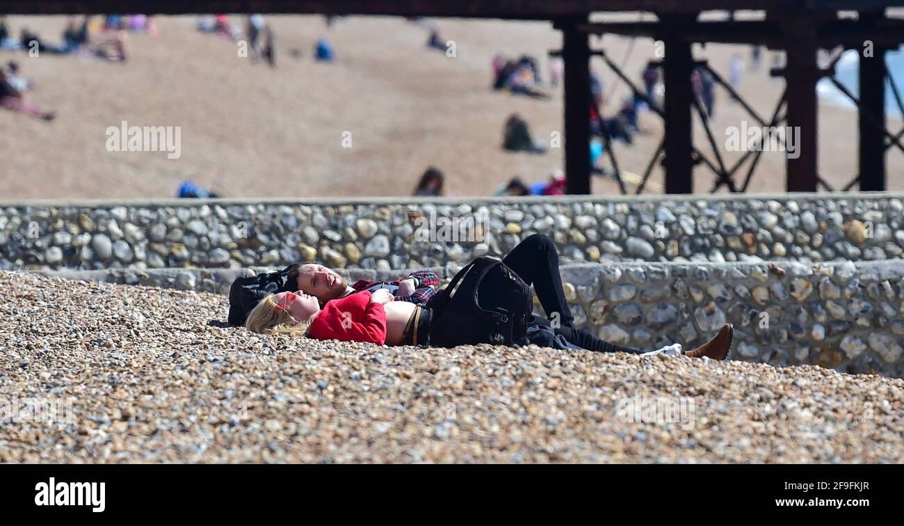 Brighton UK 18th April 2021 - Brighton seafront and beach is busy on a ...