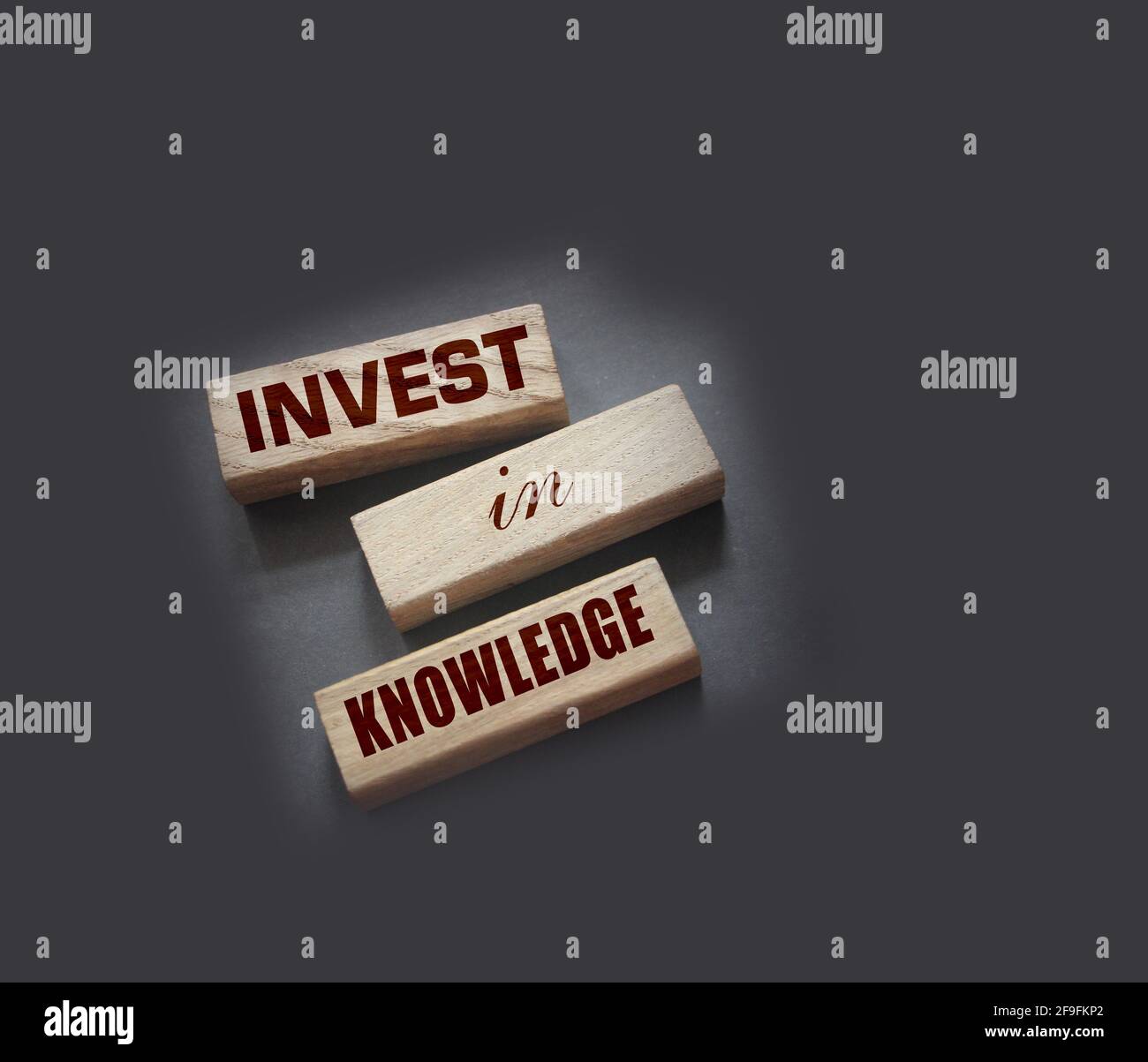Invest in knowledge words onwooden blocks. Inspirational motivational ...