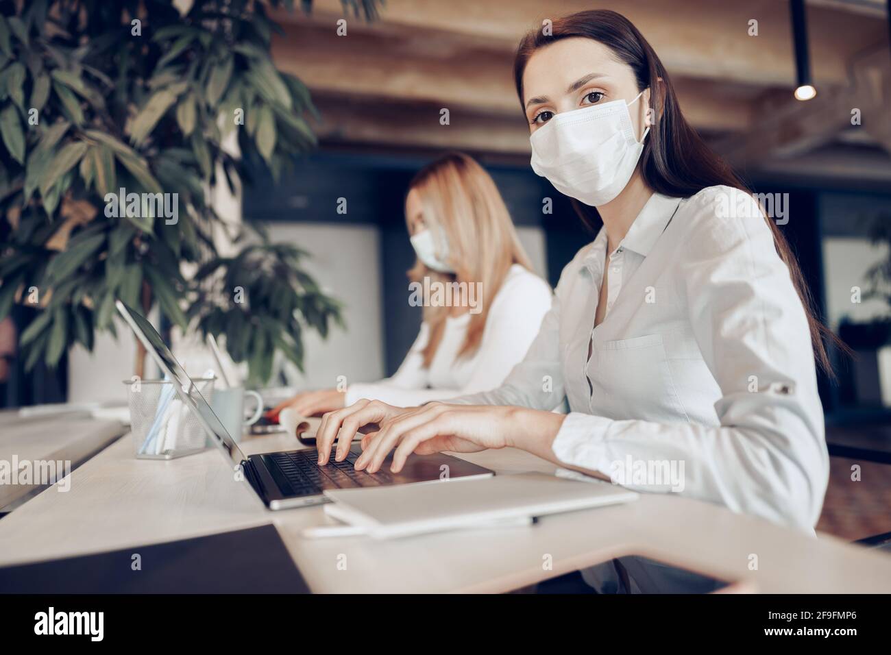 Young businesswomen wearing medical masks hi-res stock photography and ...