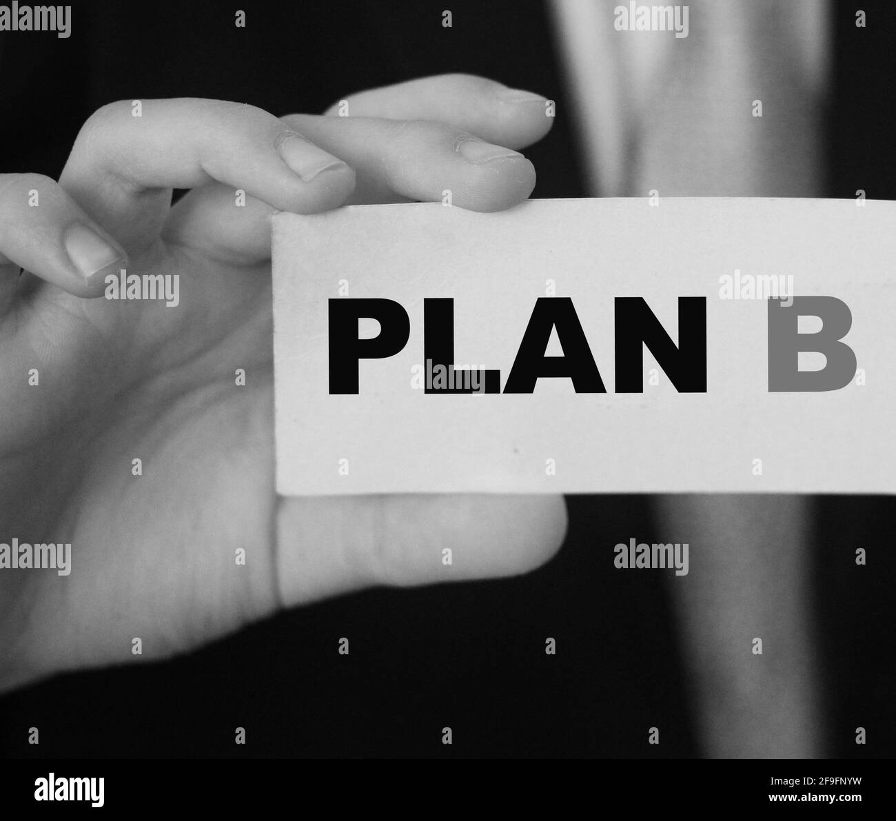 Plan B words on card in hand of businessman wearing suit and tie ...