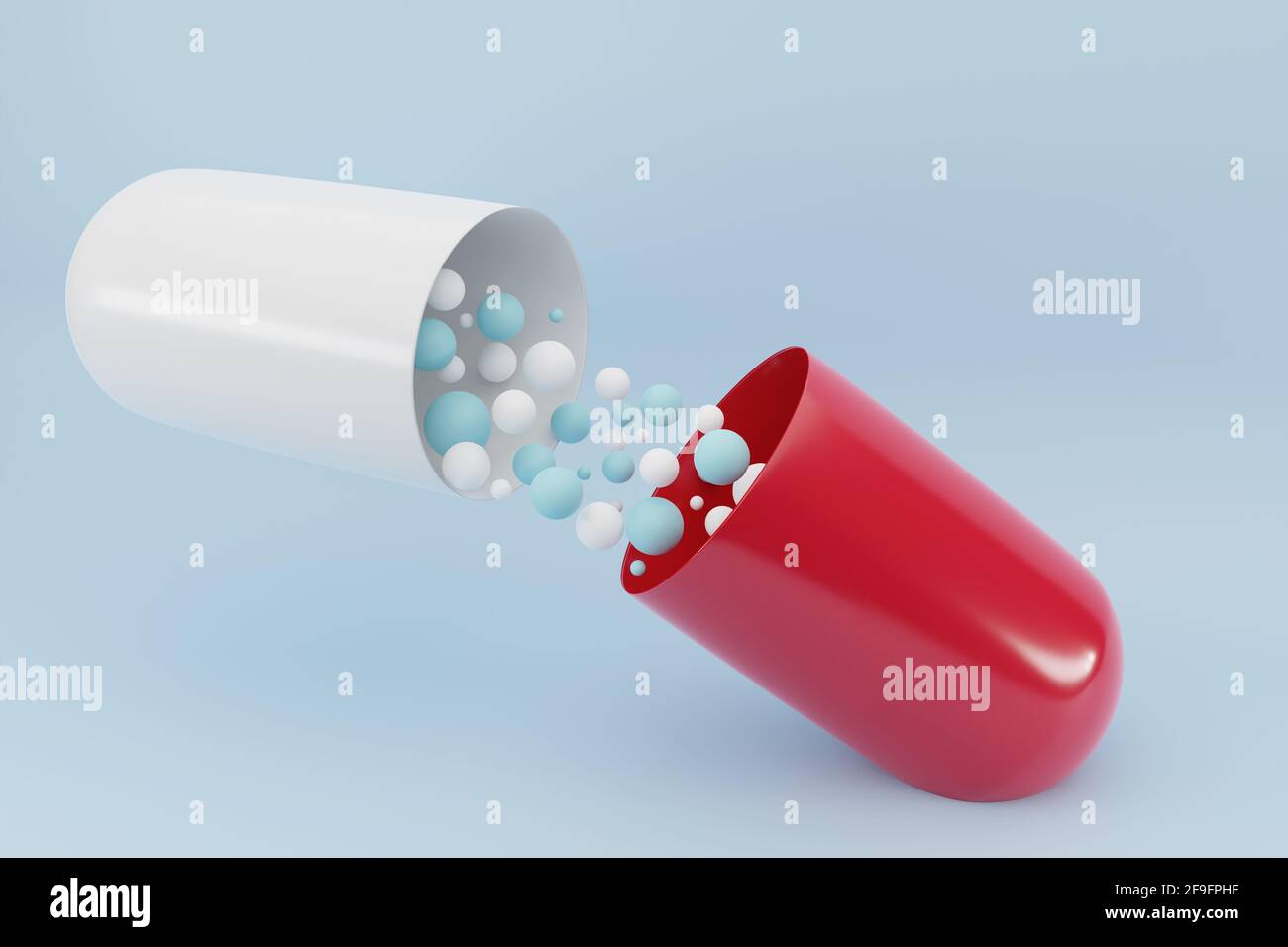 Opened two-colored capsule of medication pill with white and blue balls ...