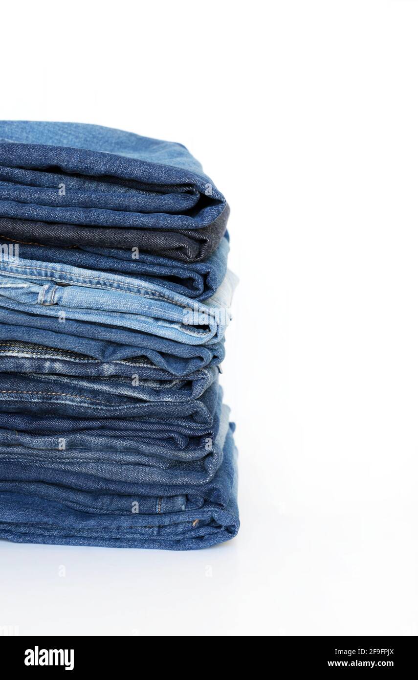 Stack of blue jeans isolated on white background. Fashion clothing ...