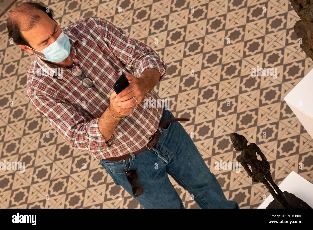 A man wearing a mask as a preventive measure against the spread of ...