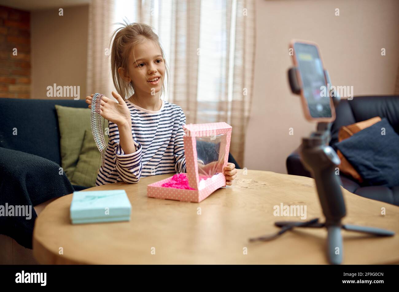 Little girl recording blog on phone camera Stock Photo - Alamy