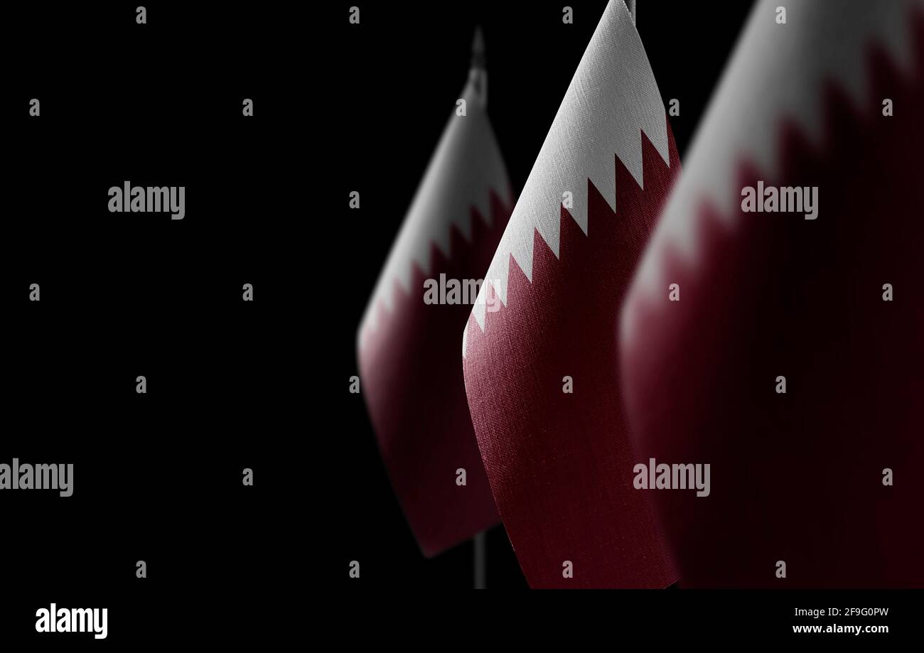 Small national flags of the Qatar on a black background Stock Photo - Alamy