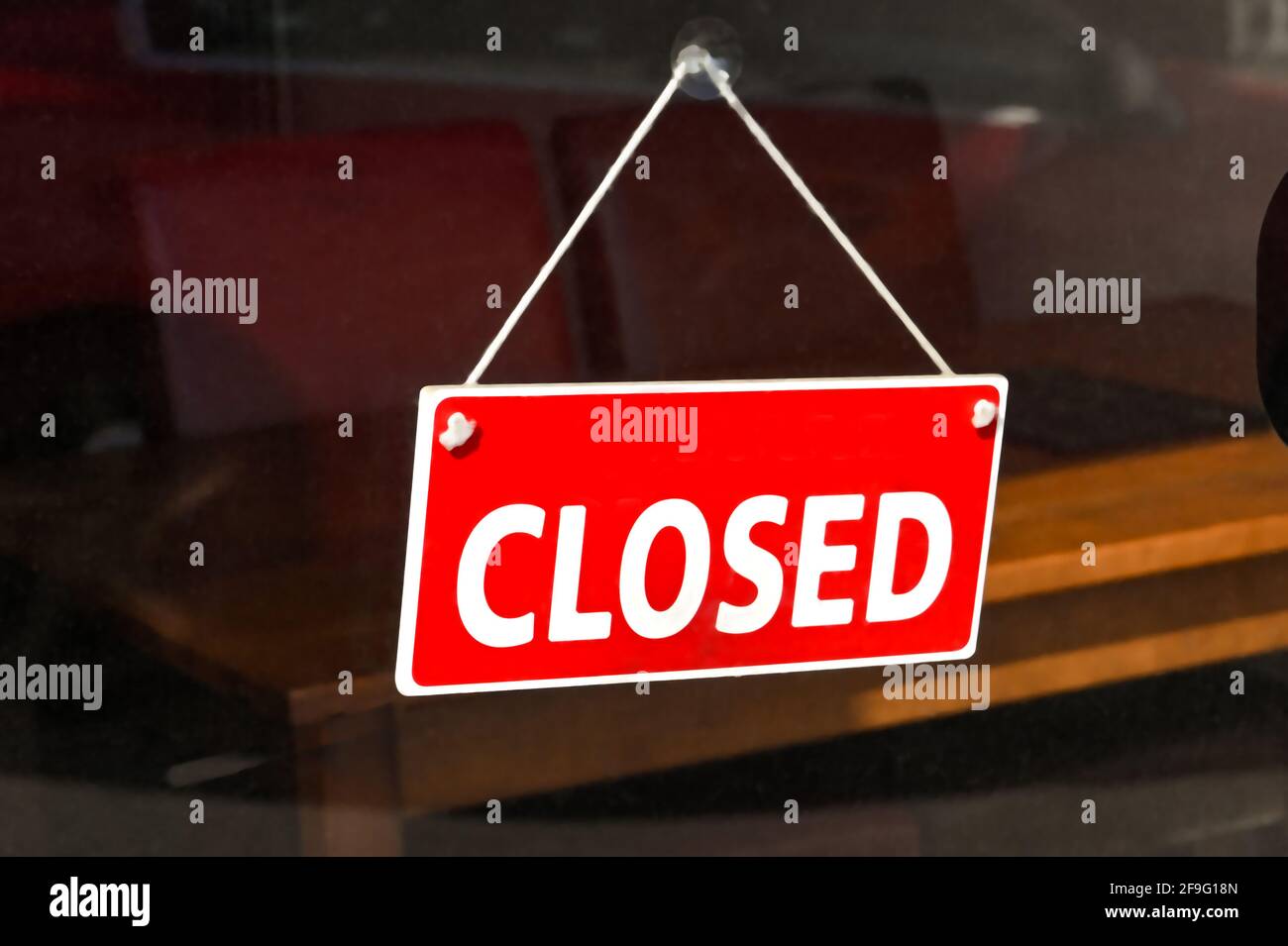 Closed sign in the window of a business which was forced to shut during ...
