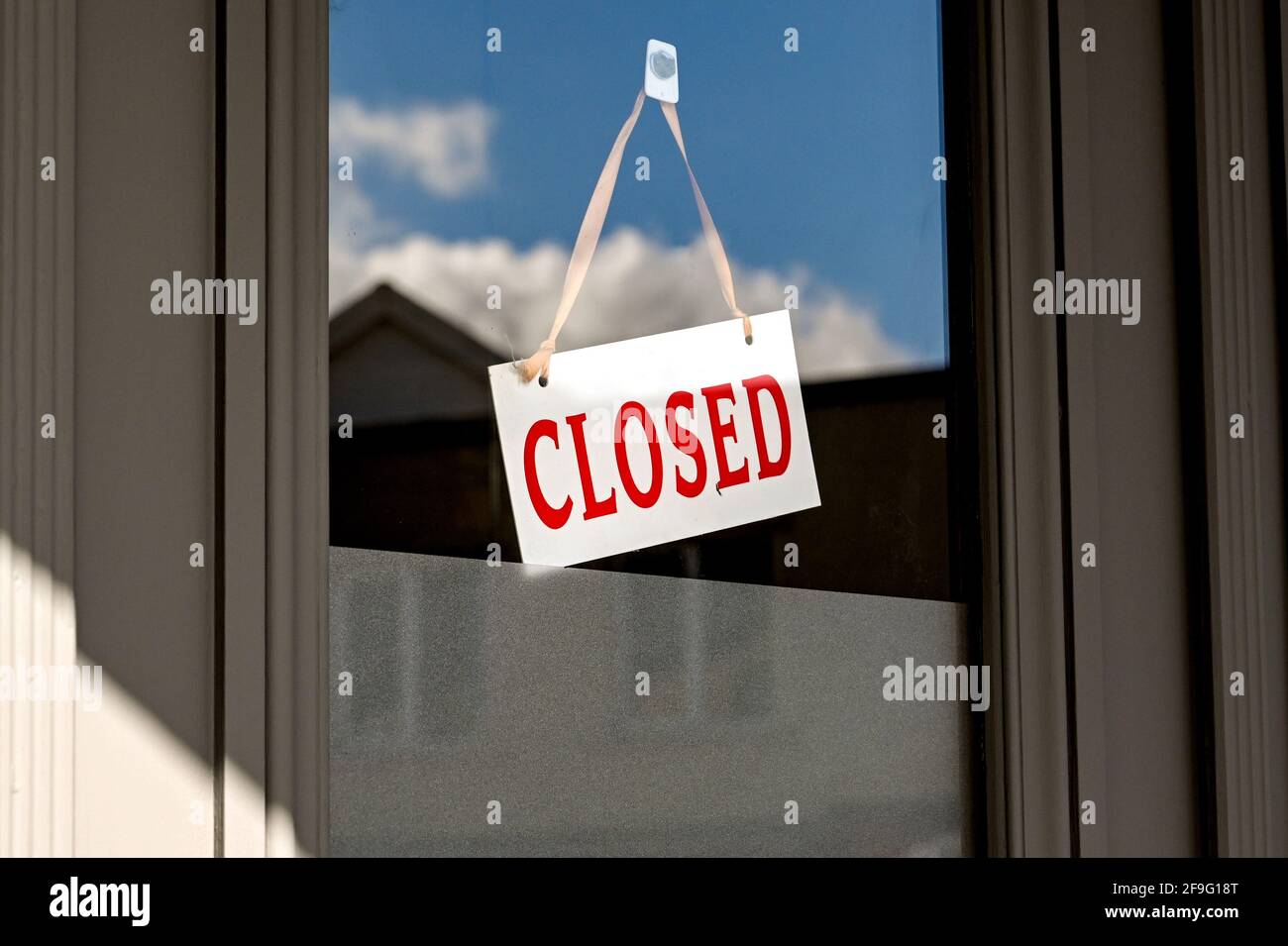 Closed sign in the window of a business which was forced to shut during ...
