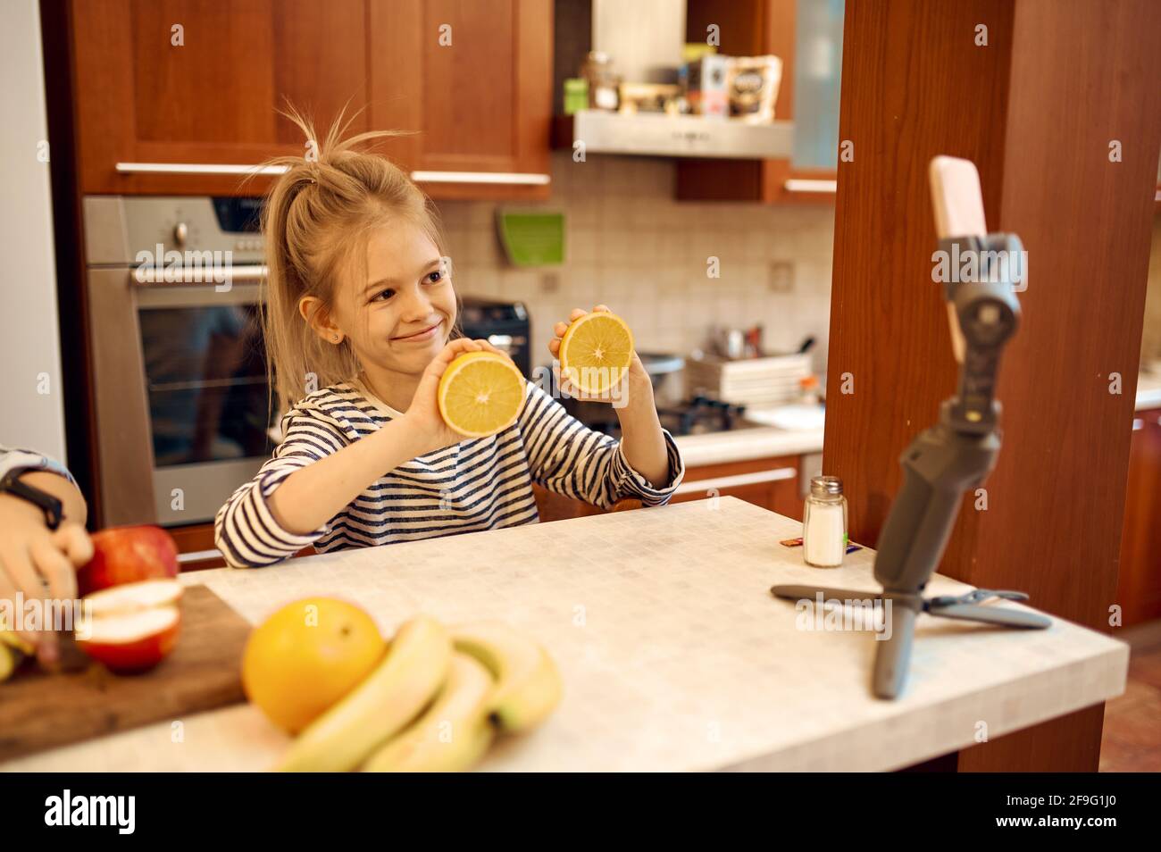 Happy little girl makes food blog, child blogger Stock Photo - Alamy