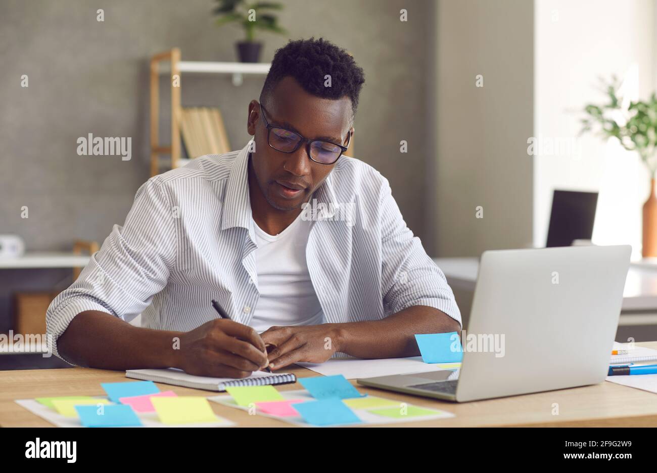 Handsome man writing on notebook hi-res stock photography and images ...