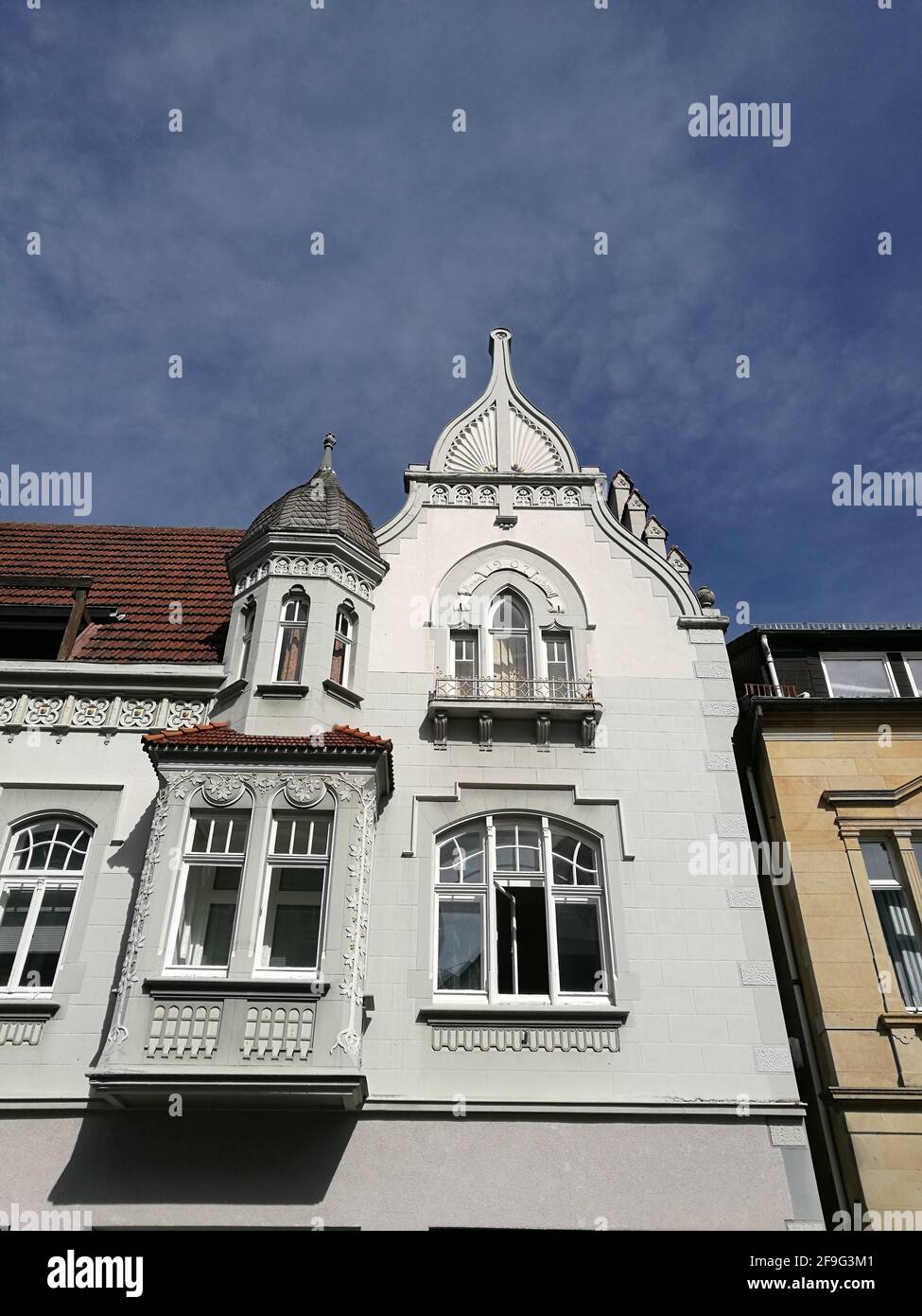 A vertical low angle shot of modern houses under blue sky Stock Photo - Alamy