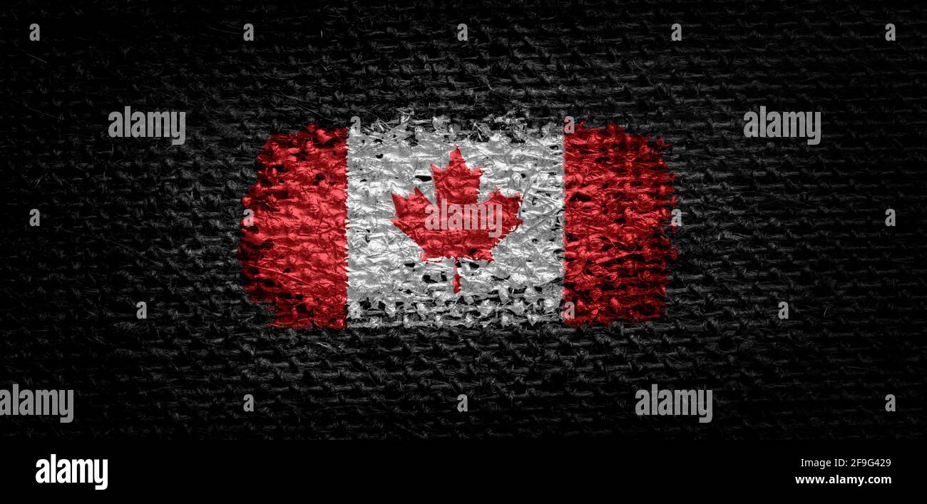 National flag of the Canada on dark fabric Stock Photo - Alamy