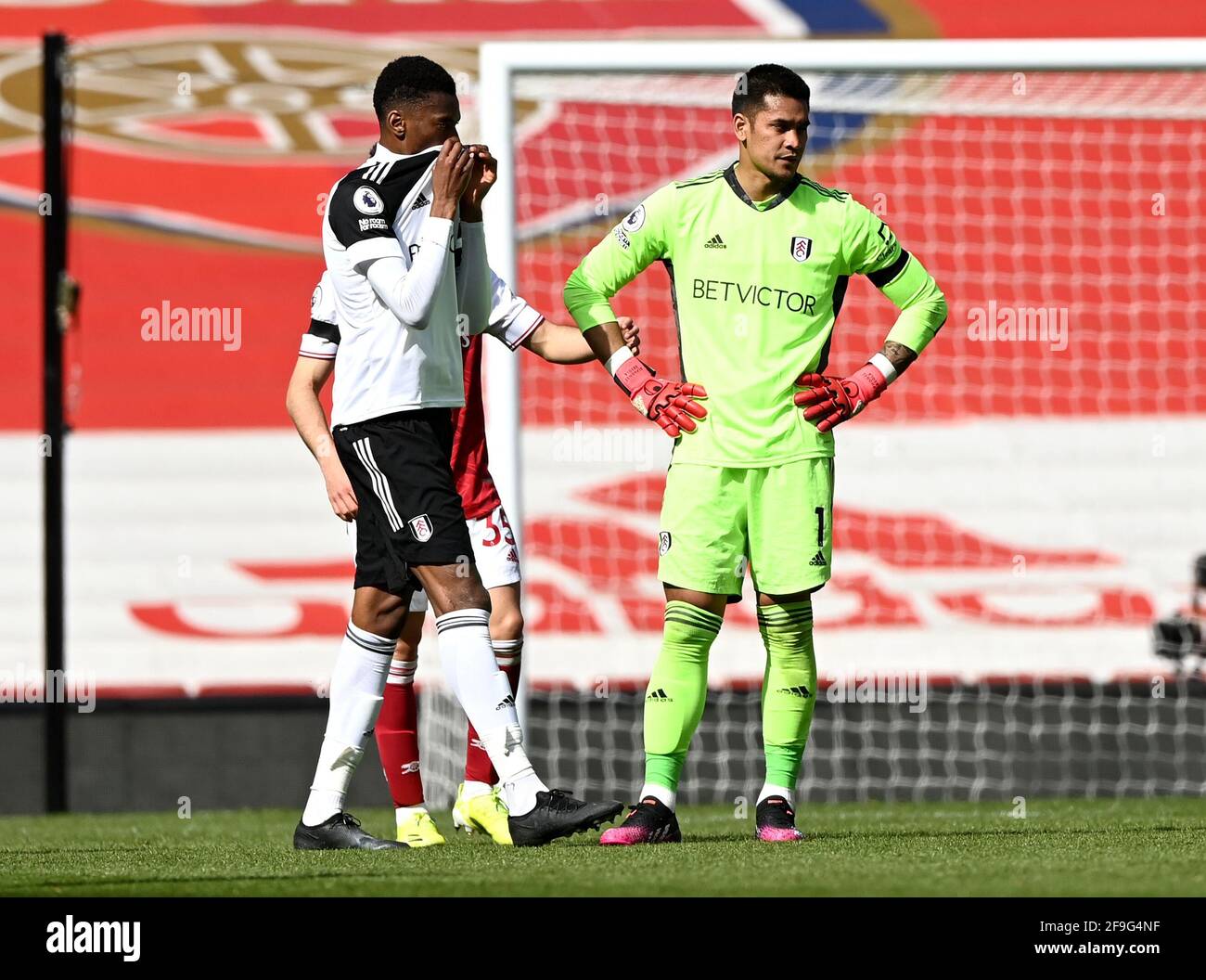 Fulham goalkeeper Alphonse Areola (right) appears dejected at the end ...