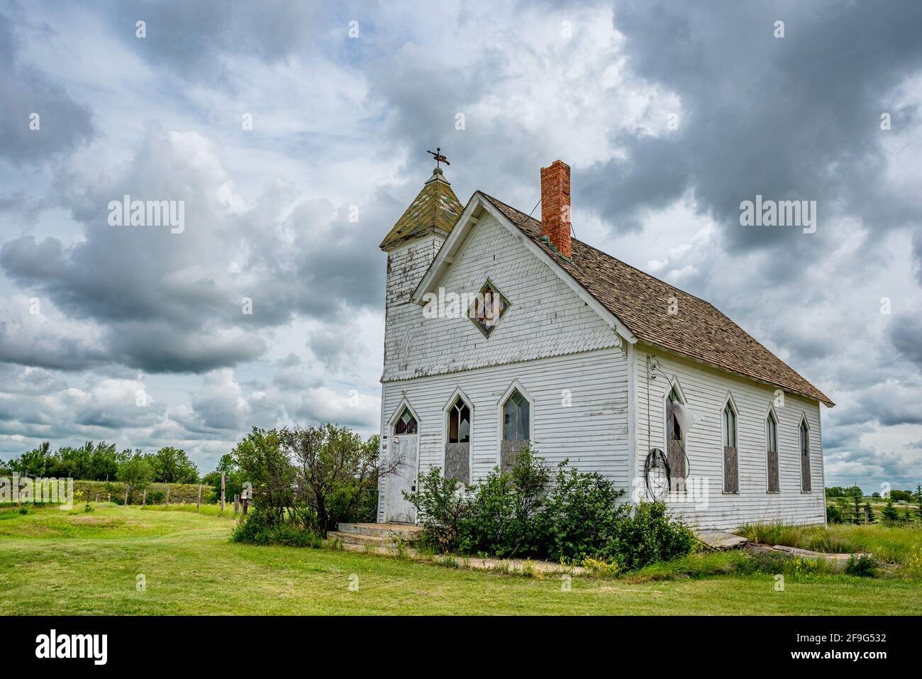Dramatic sky over the historic yet abandoned Trossachs United Church in ...