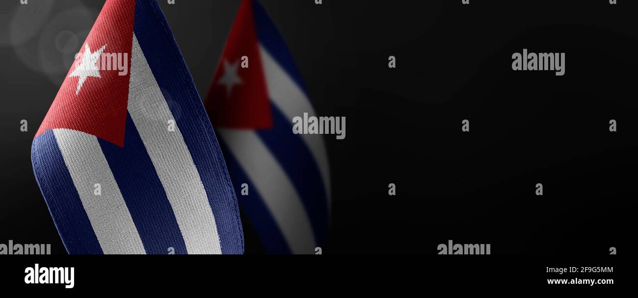 Small national flags of the Cuba on a dark background Stock Photo - Alamy
