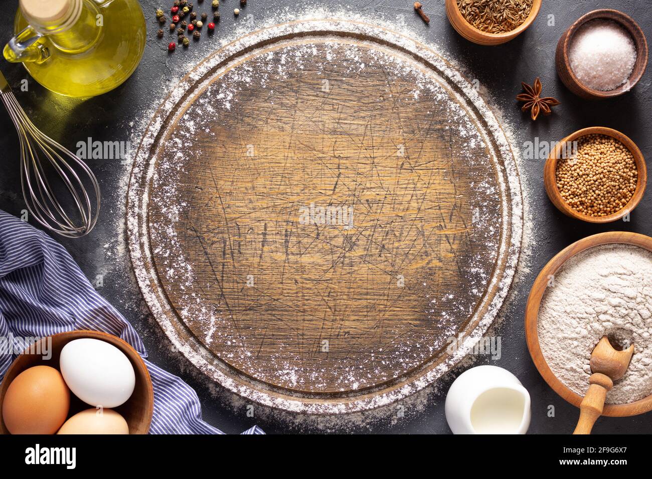 Wheat flour at wooden pizza or bread cutting board with bakery ...