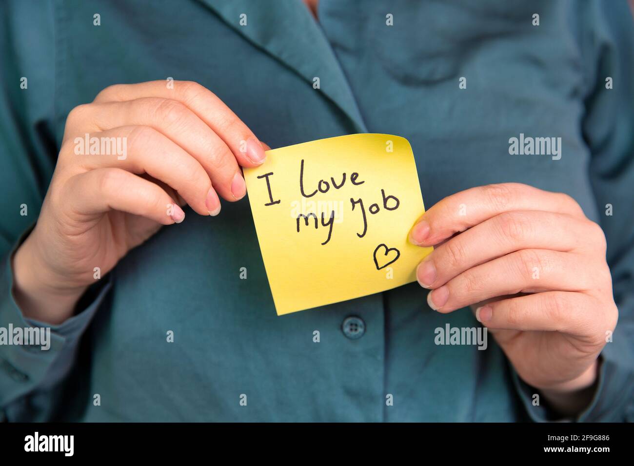 I Love My Job Note in hand, business woman or man with yellow sticky ...