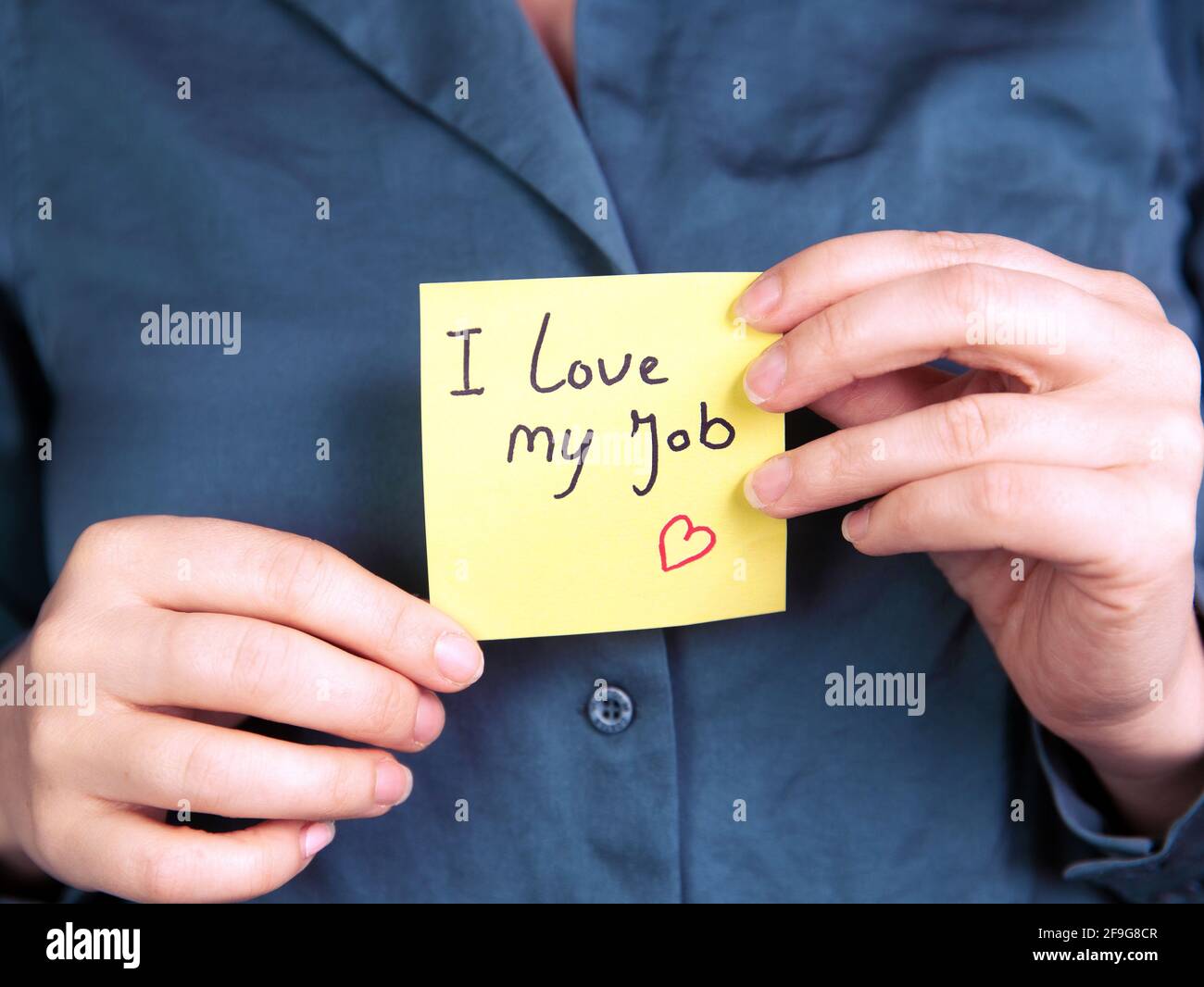 I Love My Job Note in hand, business woman or man with yellow sticky ...