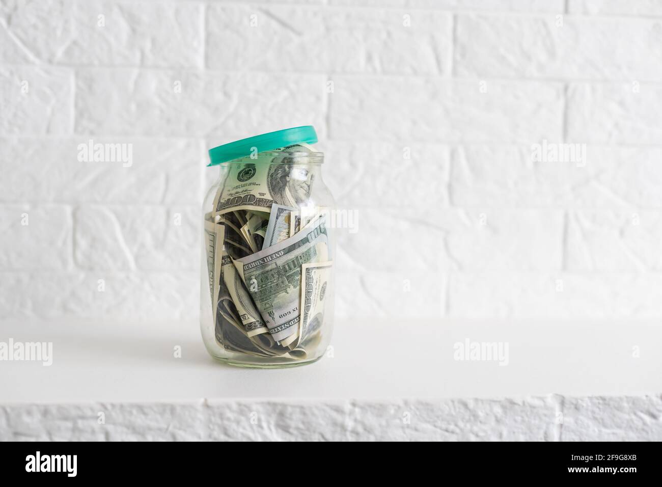 100 dollar bills jar hi-res stock photography and images - Alamy