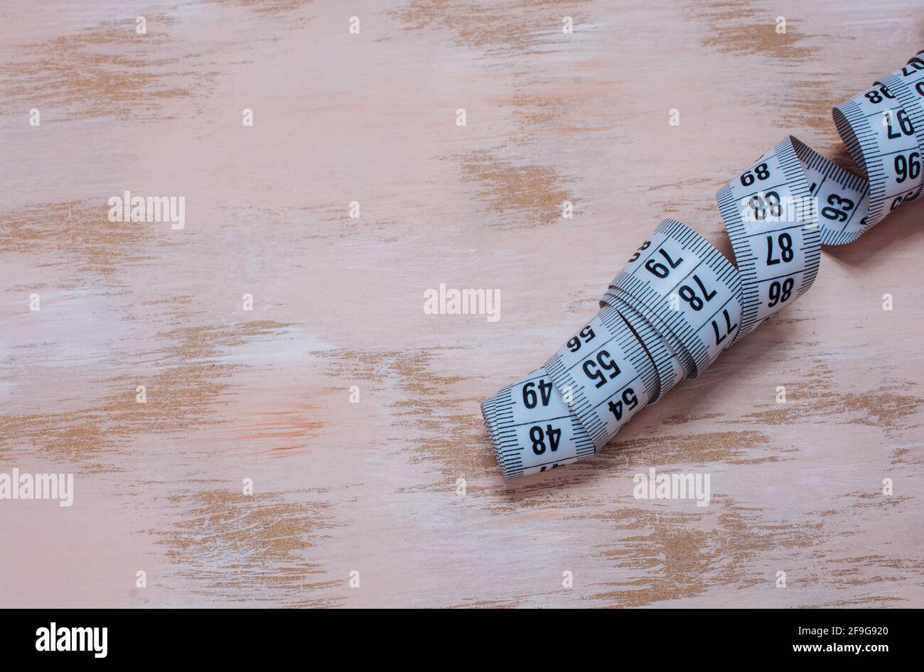 A top view of a soft tailor tape measure for cloth sewing on a textured ...